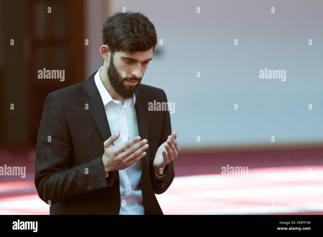 Younger Muslim man praying in colorful mosque Stock Photo - Alamy