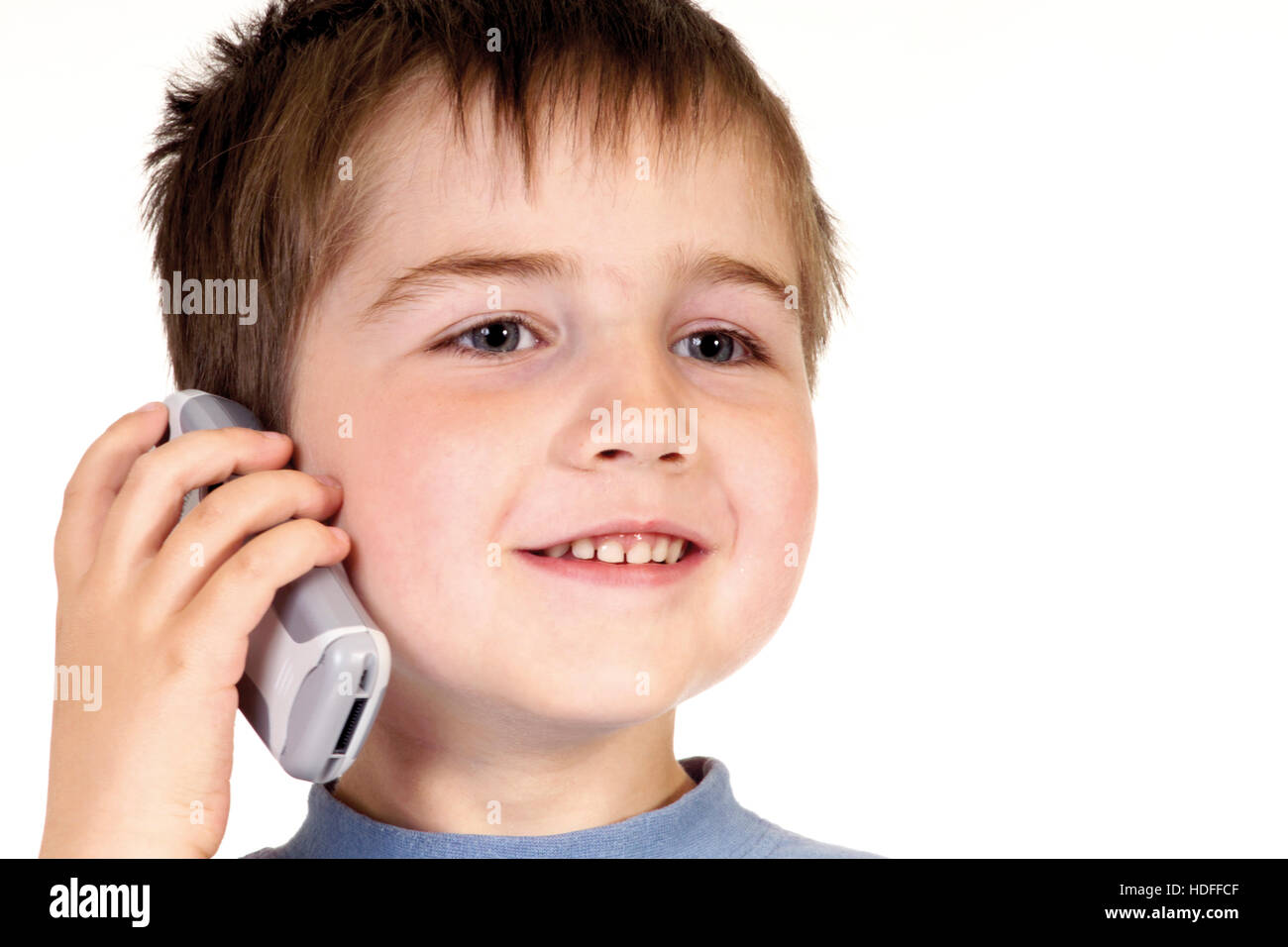 Young boy talking on a telephone Stock Photo - Alamy