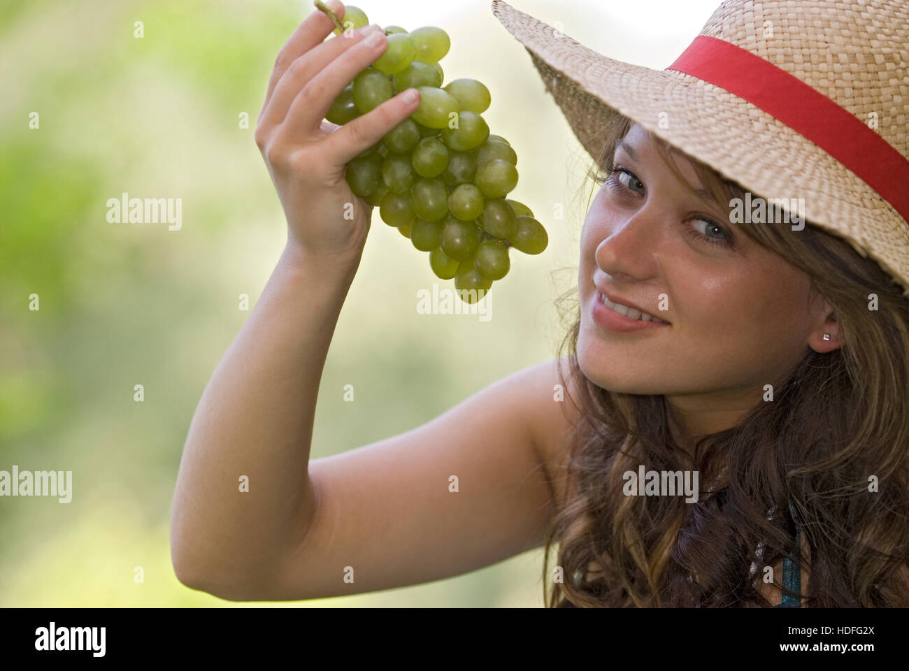 A woman eating grapes Stock Photo - Alamy