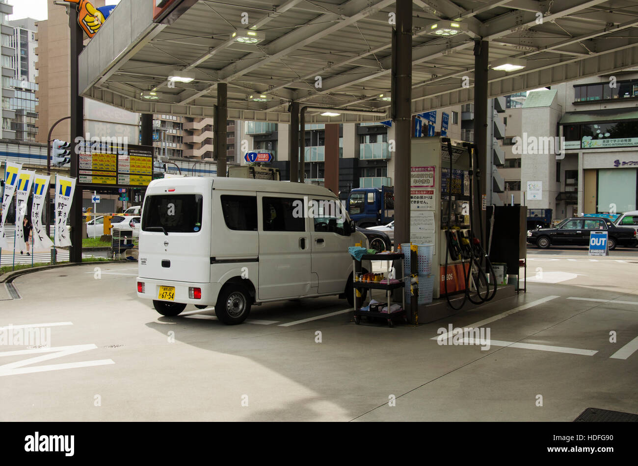 Japanese people drive van go to fill oil in petrol station at Shinjuku ...