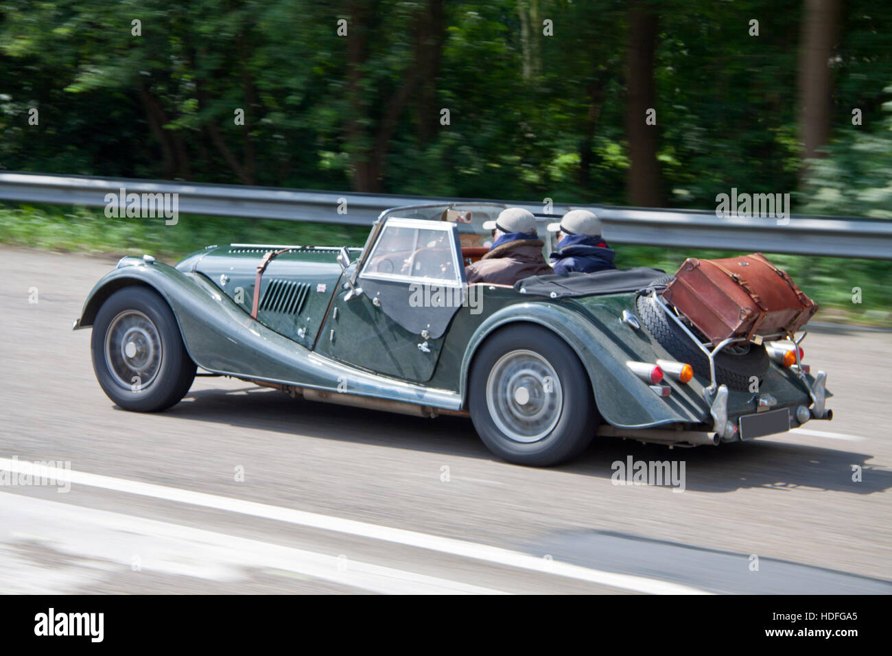 Old classic car driving on the highway for background use Stock Photo ...