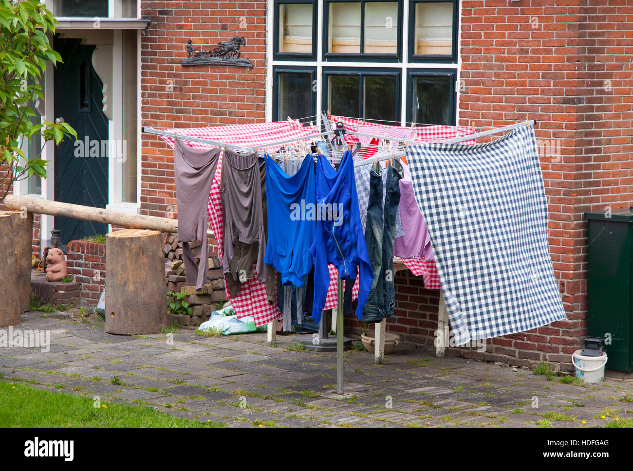 Drying frame with clean laundry in front of a house for background use ...