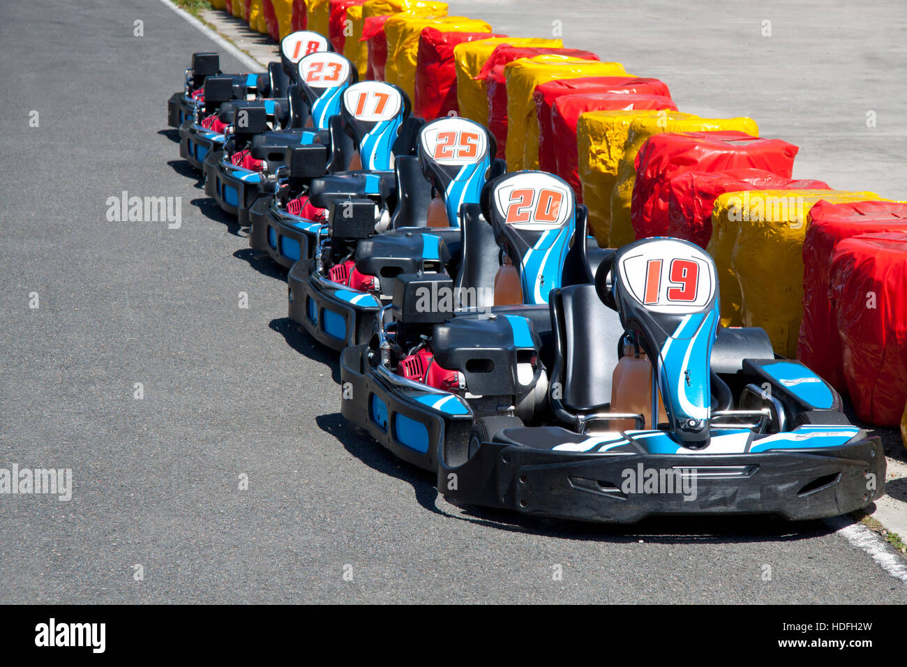 Carting-cars in a row in front of a barrier for background use Stock ...