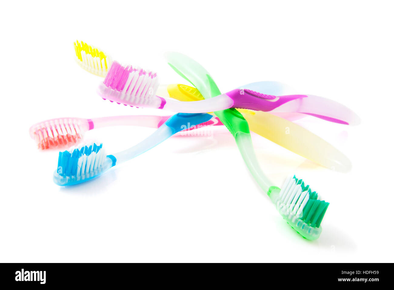 Colorful toothbrushes on a pile isolated over white Stock Photo - Alamy