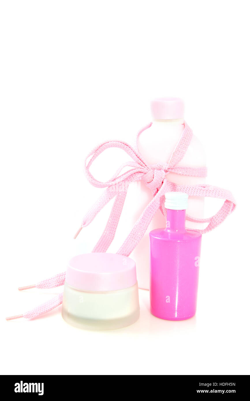 Three pink bodycare objects isolated over white Stock Photo - Alamy