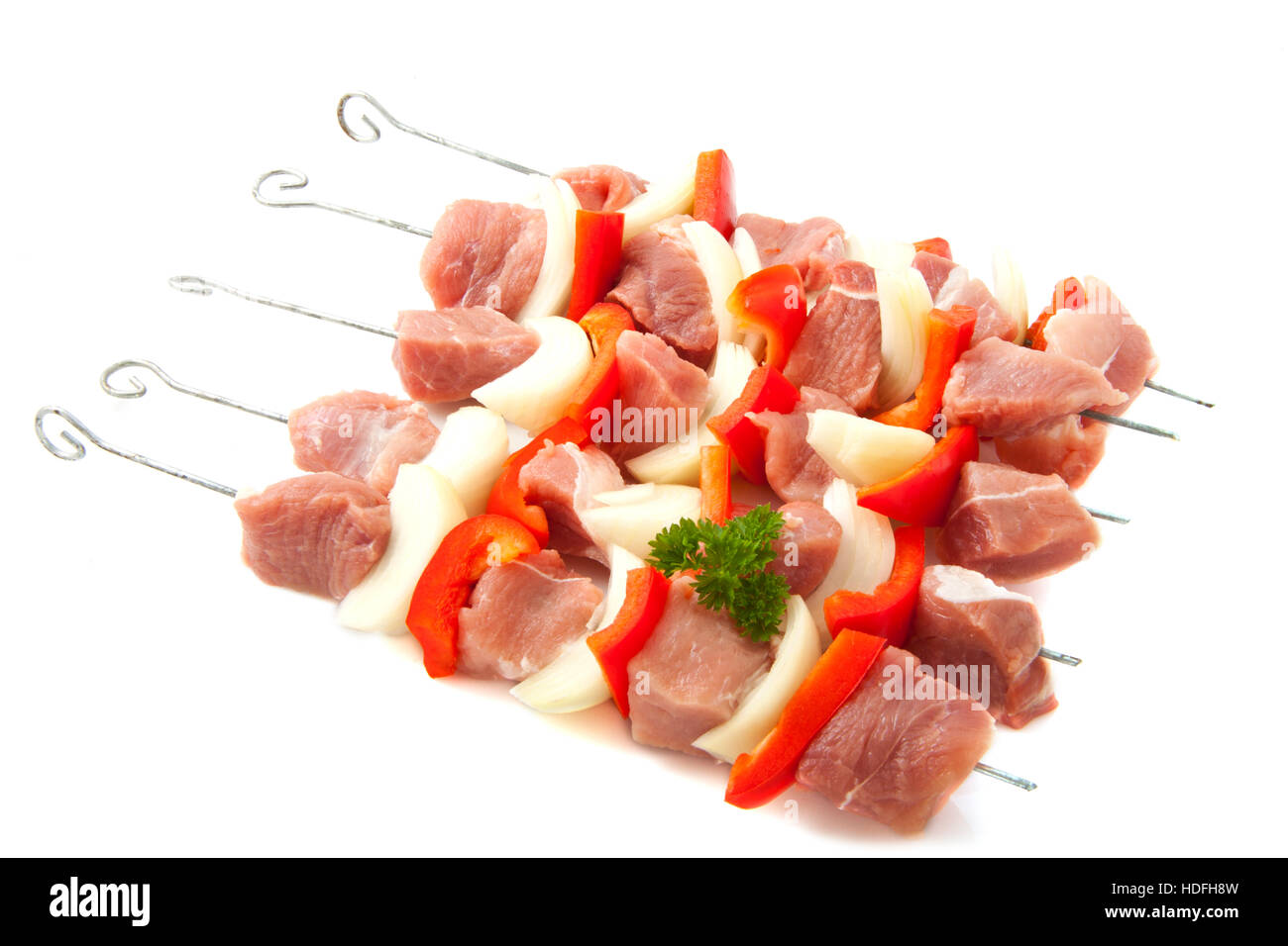 Raw meat on sticks in a row isolated over white Stock Photo - Alamy