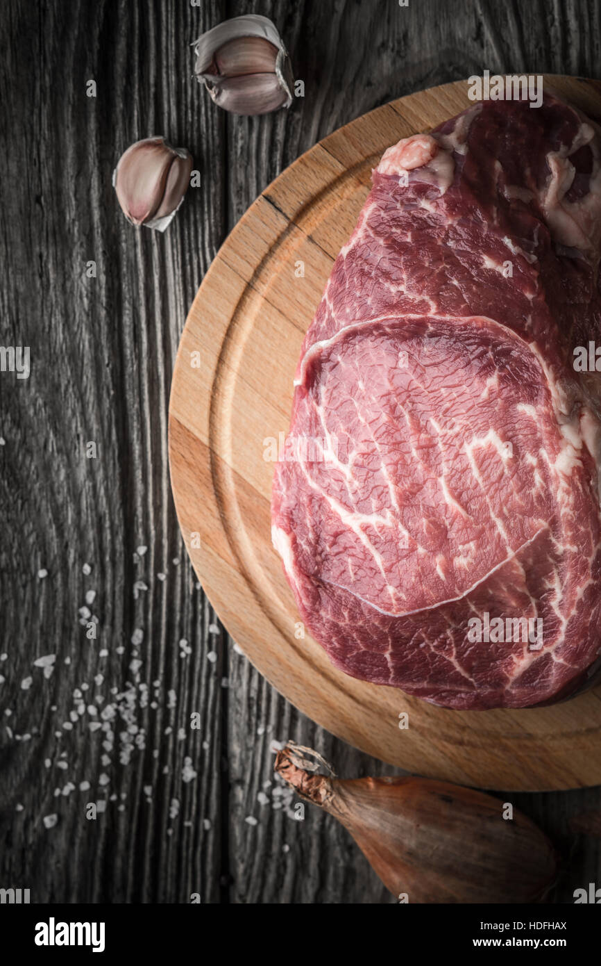 Raw angus beef with seasoning on the wooden table vertical Stock Photo ...
