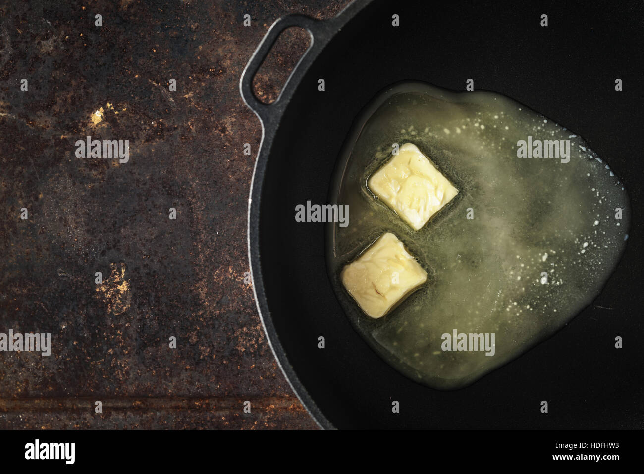 Pieces of butter in the hot pan top view Stock Photo - Alamy