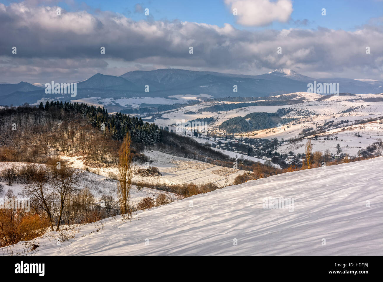 village on hillside with snow in mountain area in winter Stock Photo ...