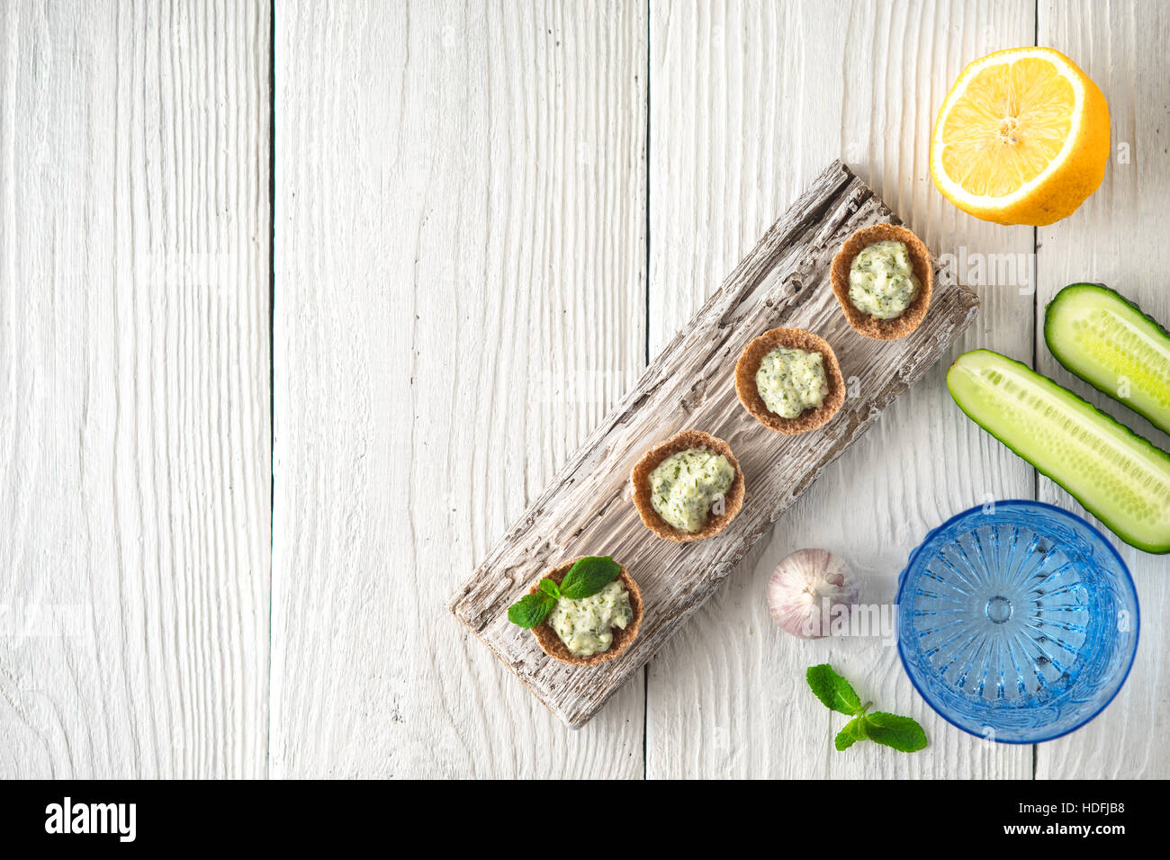 Crisp bread with tzatziki on the white wooden table top view Stock ...