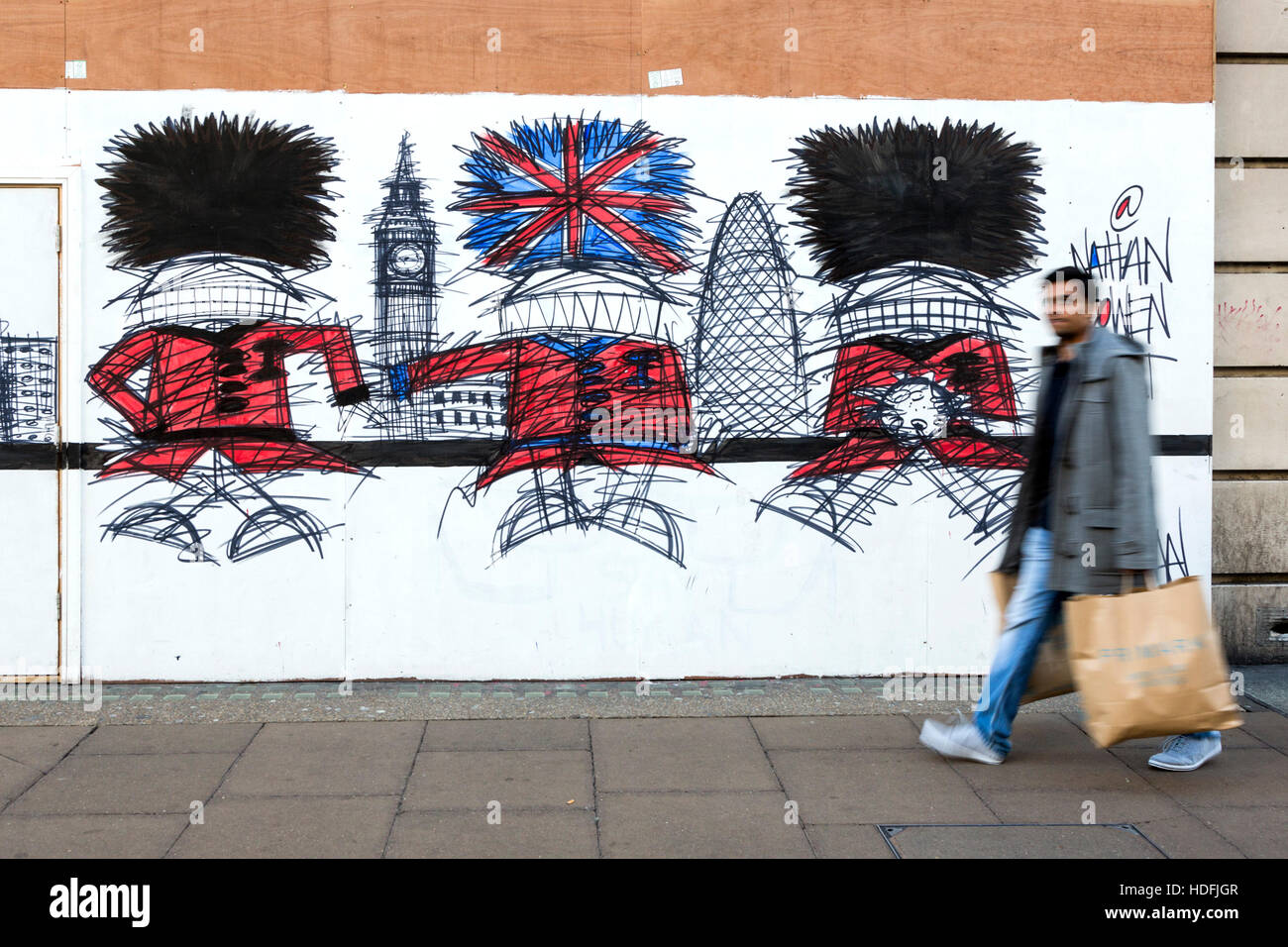 Shoppers walking in front of a graffiti of Guardsmen by Nathan Bowen ...