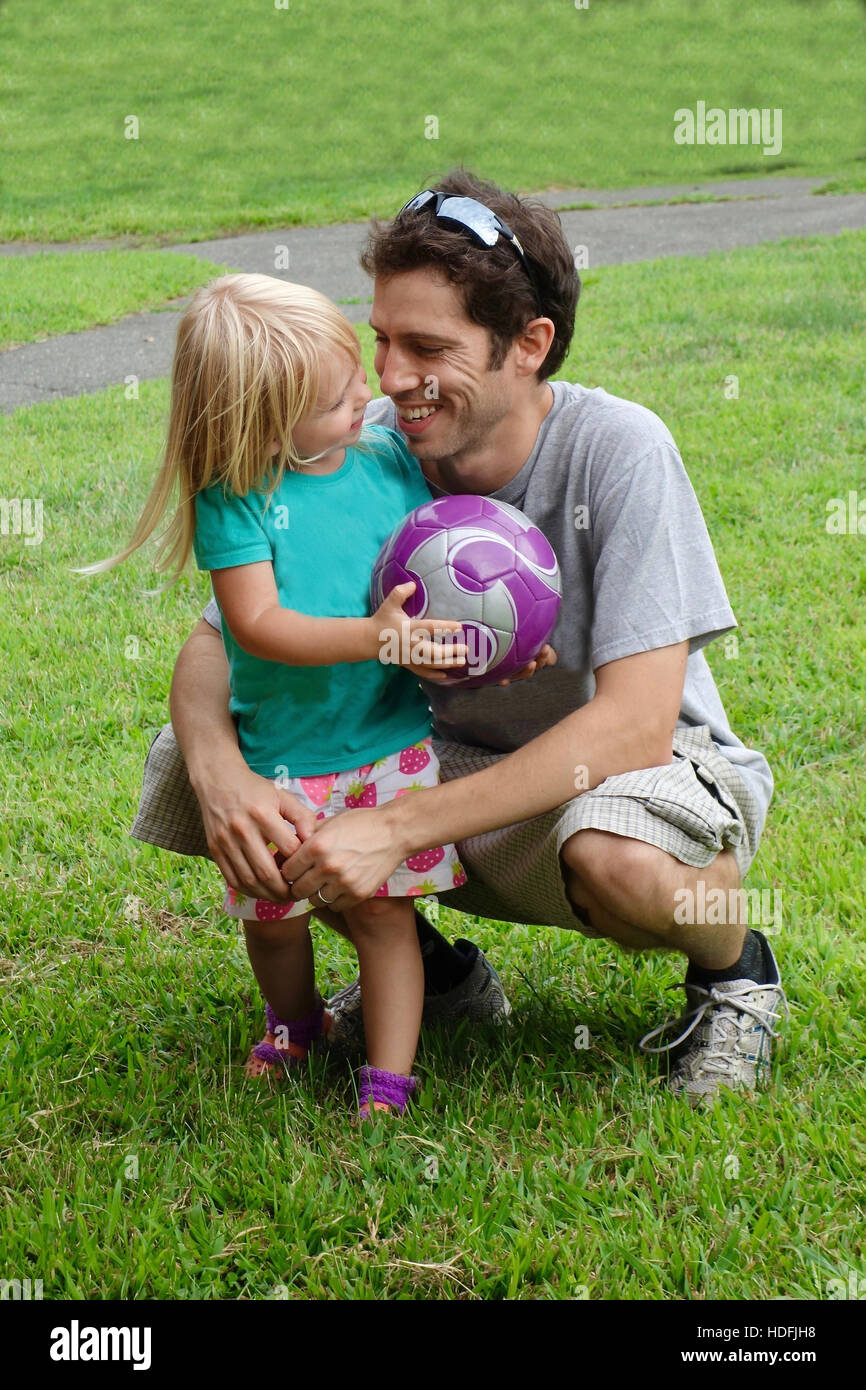 Dad and daughter playing football hi-res stock photography and images ...