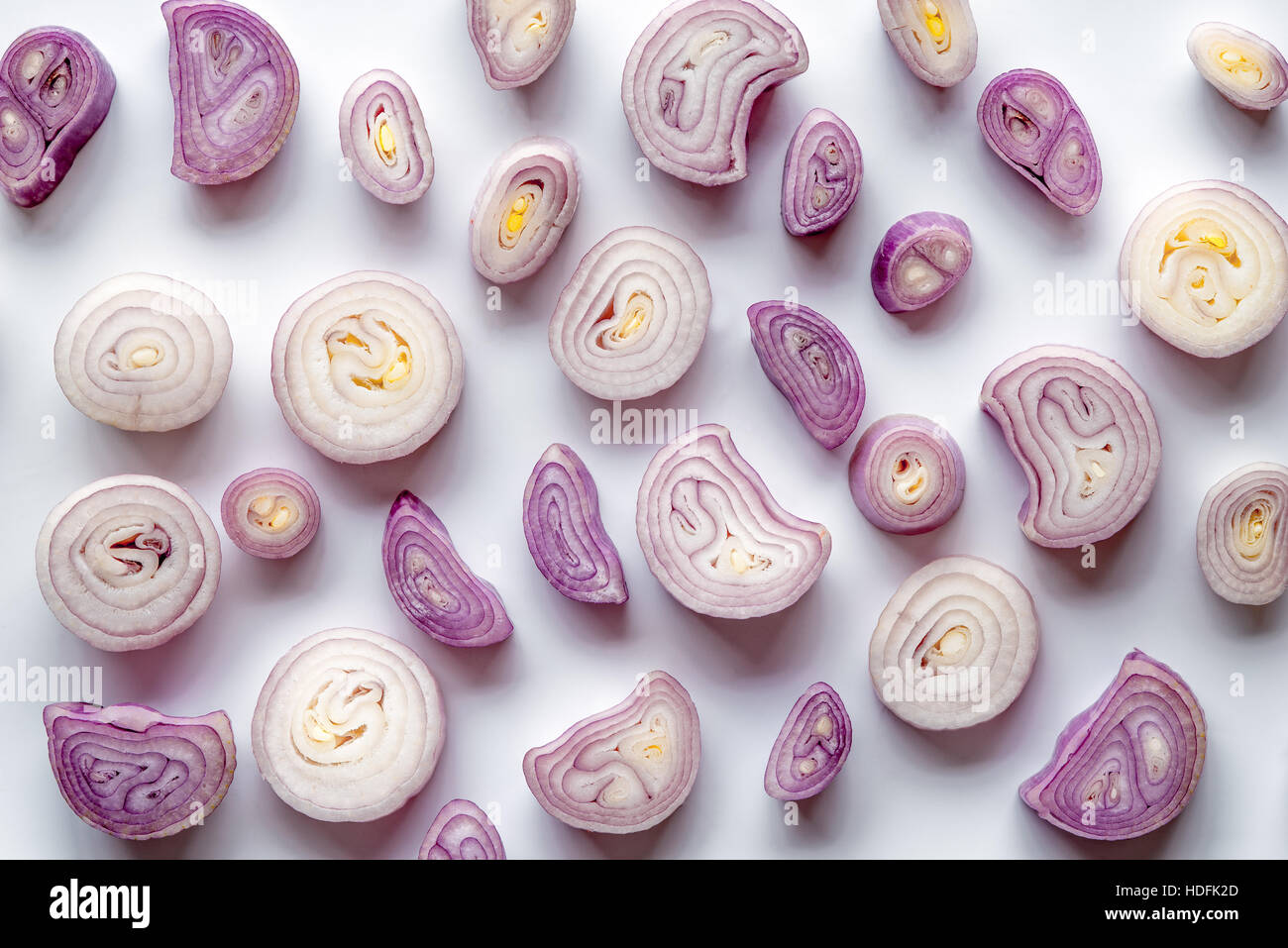 Sliced shallot on the white background top view Stock Photo - Alamy