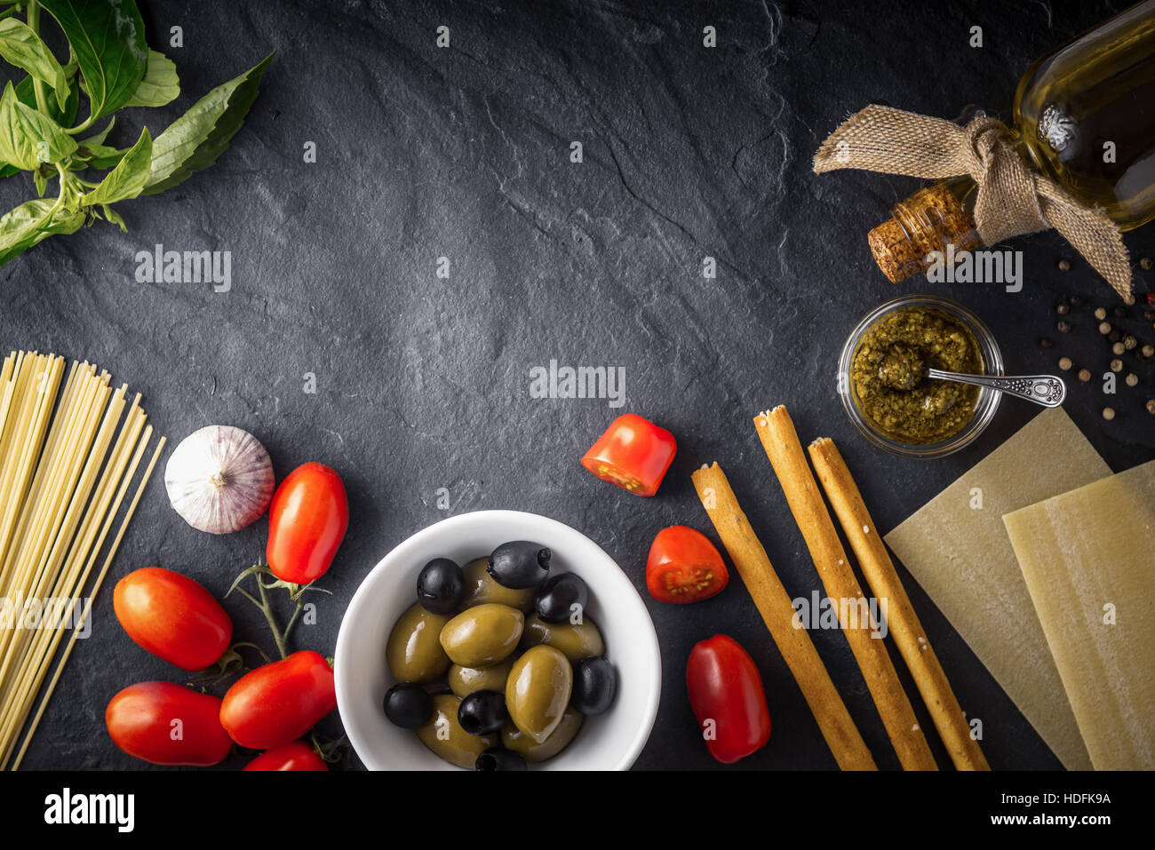 Italian food mix on the black stone table top view Stock Photo - Alamy