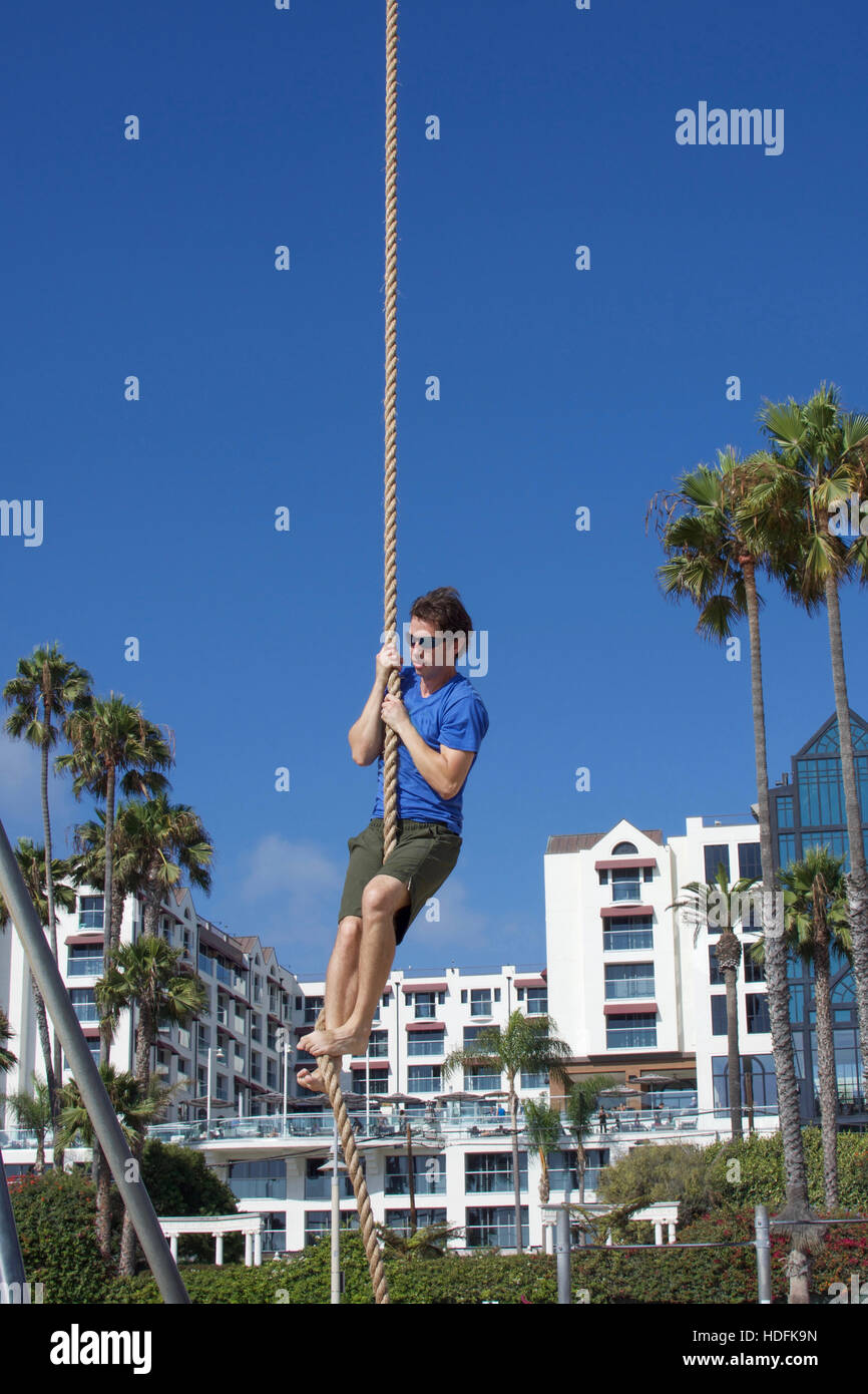 young man climbing rope on Santa Monica Beach California Stock Photo ...