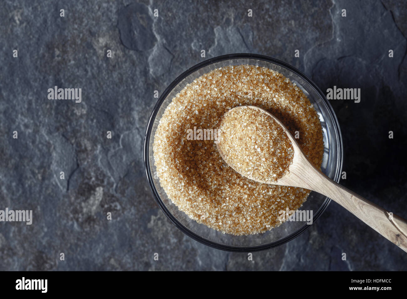 Brown sugar in the glass bowl on the stone background top view Stock ...