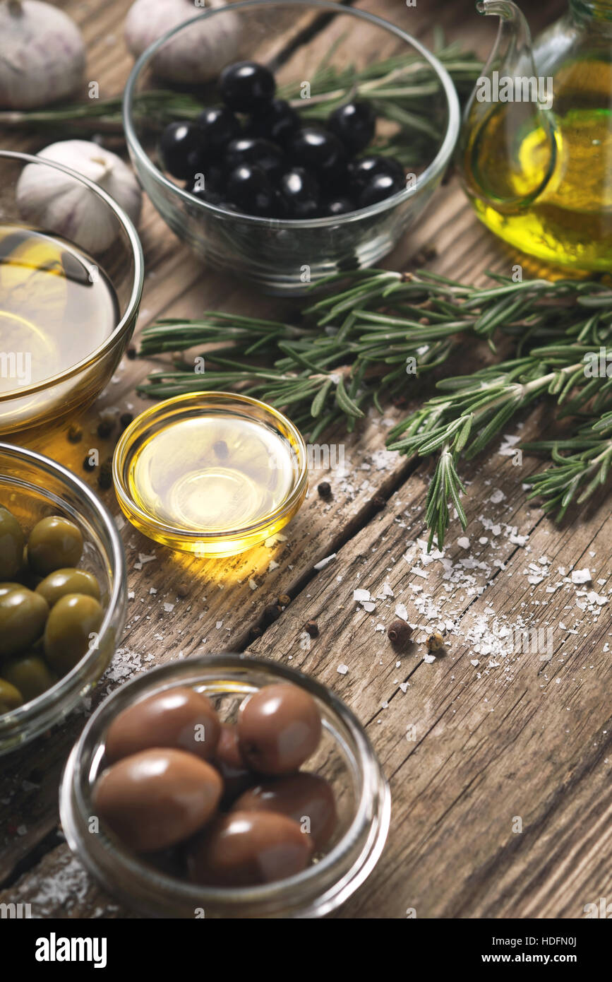 Olives with different seasoning on the wooden table Stock Photo - Alamy