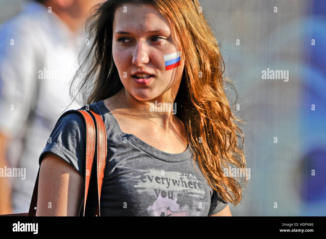 Russian sports fan (woman) with her face painted with the Russian flag ...