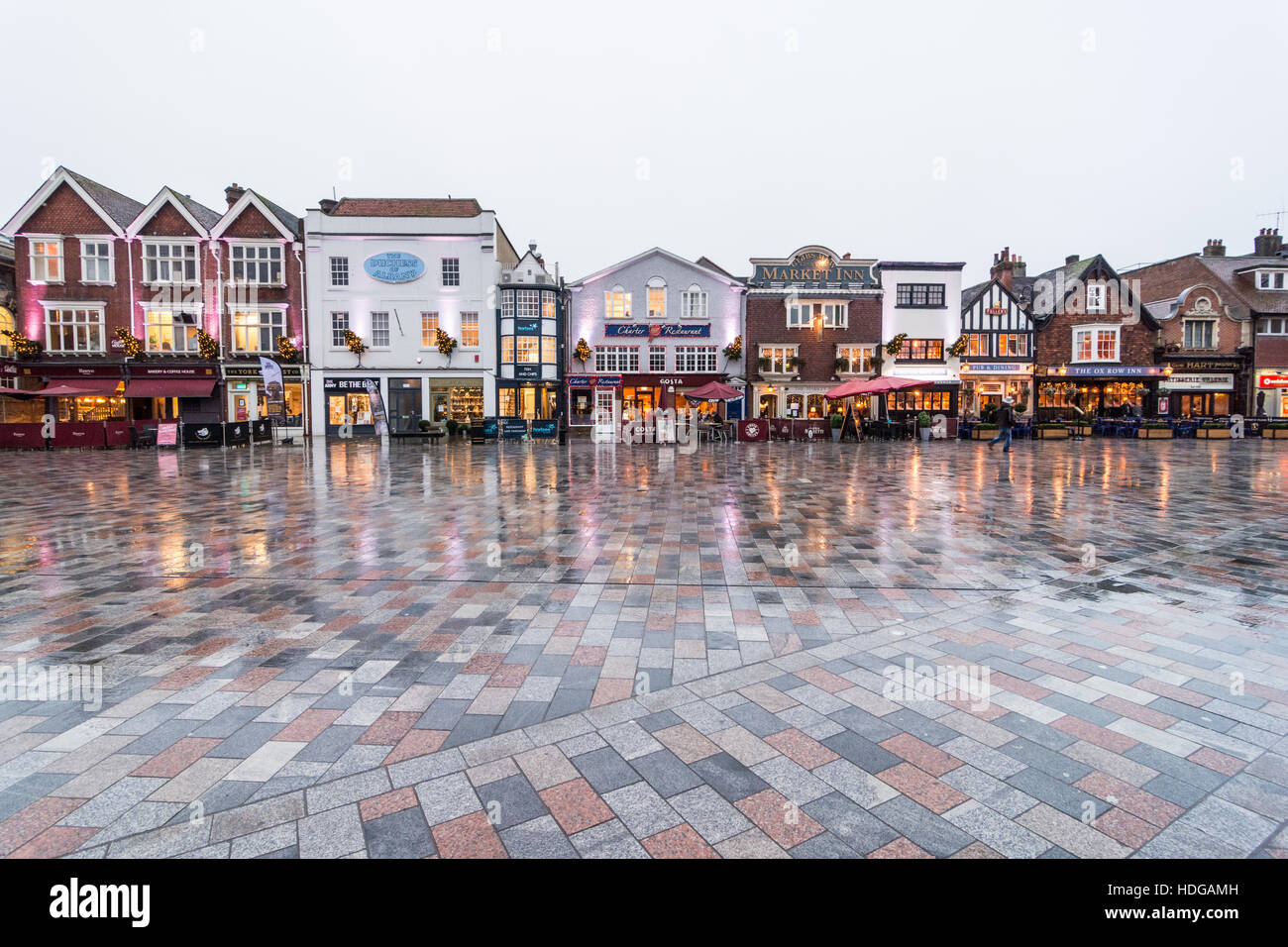 Salisbury Market Square, Wiltshire, UK in December, pre Christmas. Wet with reflection in paving ...