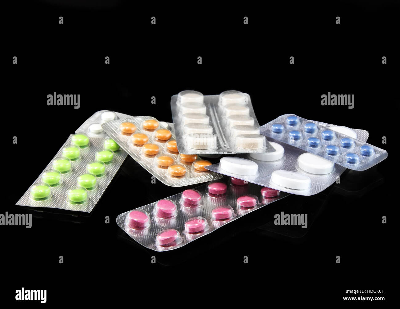 Coloured pills on black background.Close-up Stock Photo - Alamy