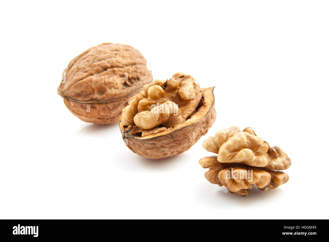 Three fresh walnuts in a row on a white background Stock Photo - Alamy