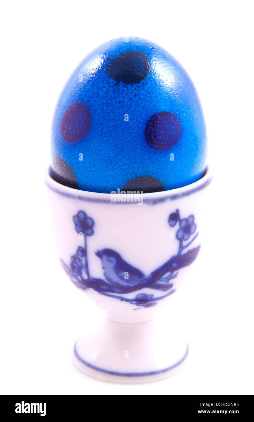 Blue spotted egg in decorated egg cup isolated over white Stock Photo ...