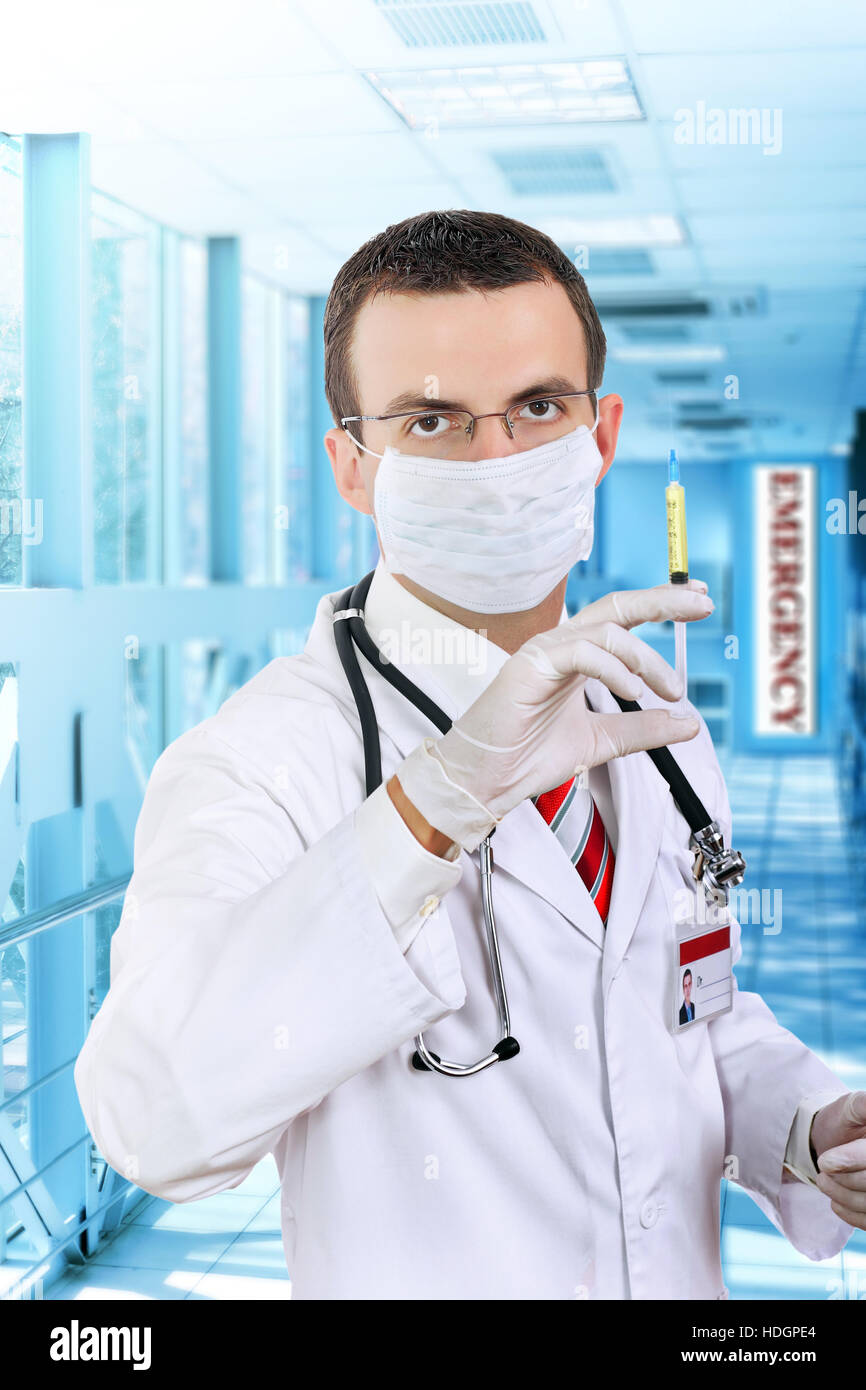 Doctor stand and hold a medical syringe with medication in Hospital ...