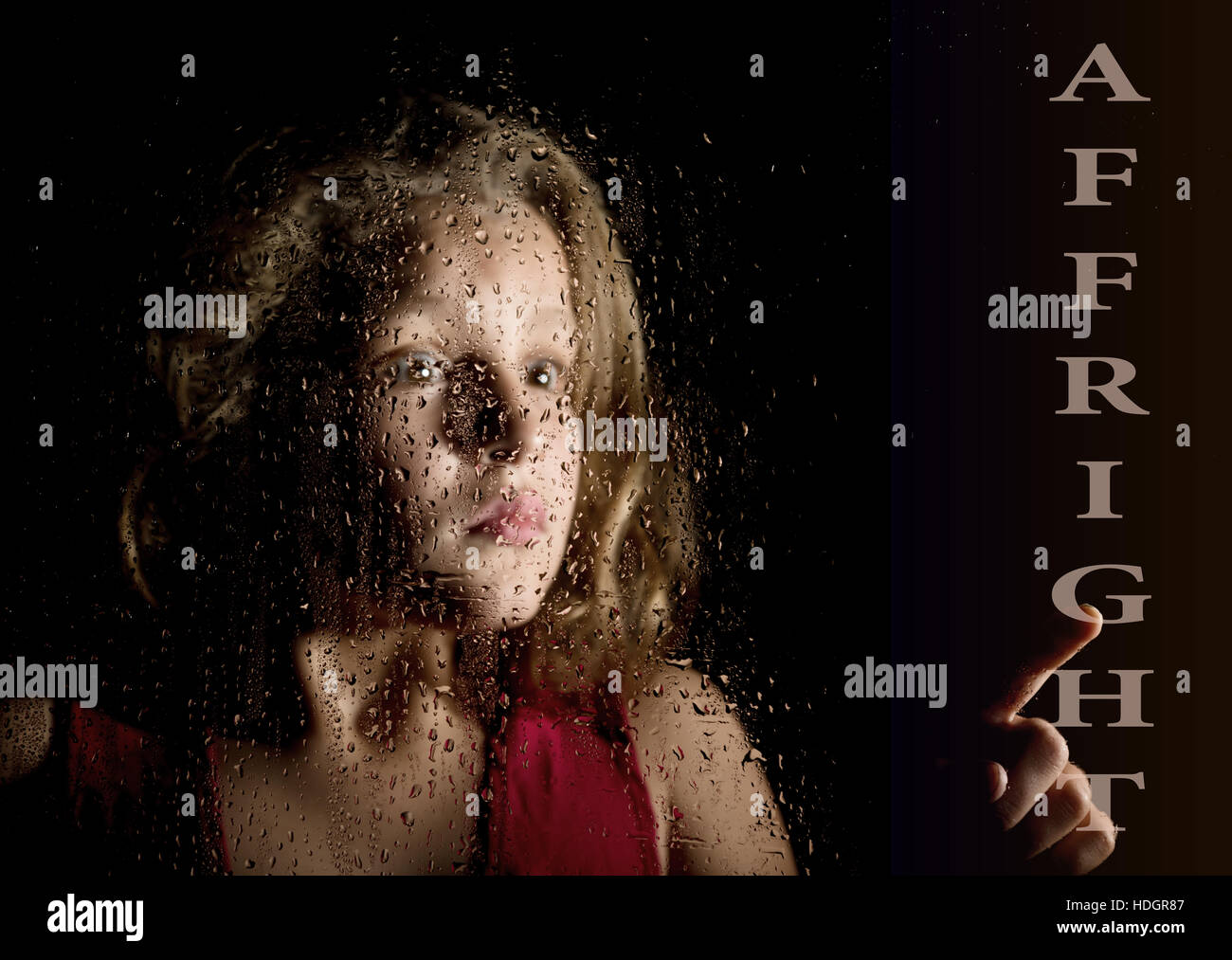 affright written on virtual screen. hand of frightened young girl ...