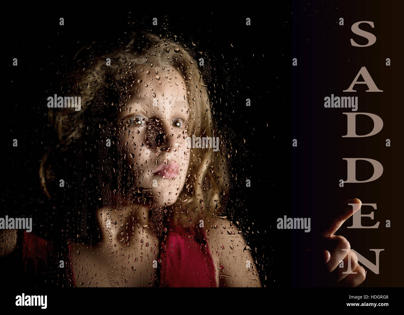 sadden written on virtual screen. hand of frightened young girl ...