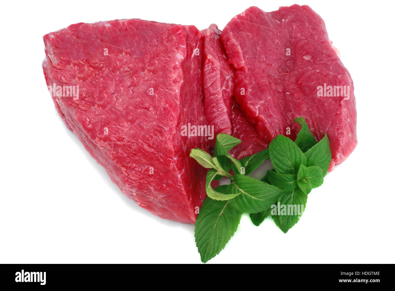 Cut of beef steak with green leaf. Isolated Stock Photo - Alamy