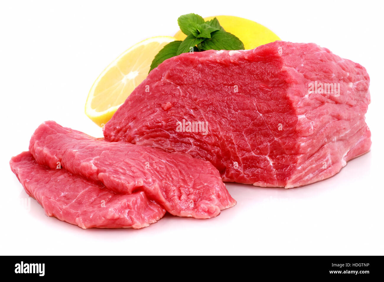 Cut of beef steak with lemon slice. Isolated Stock Photo - Alamy
