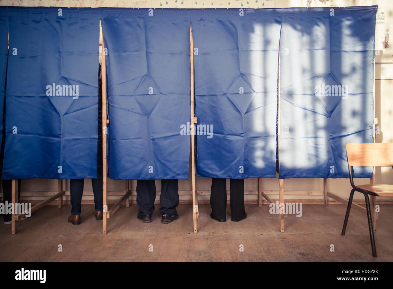 People vote in a voting booth at a polling station Stock Photo - Alamy