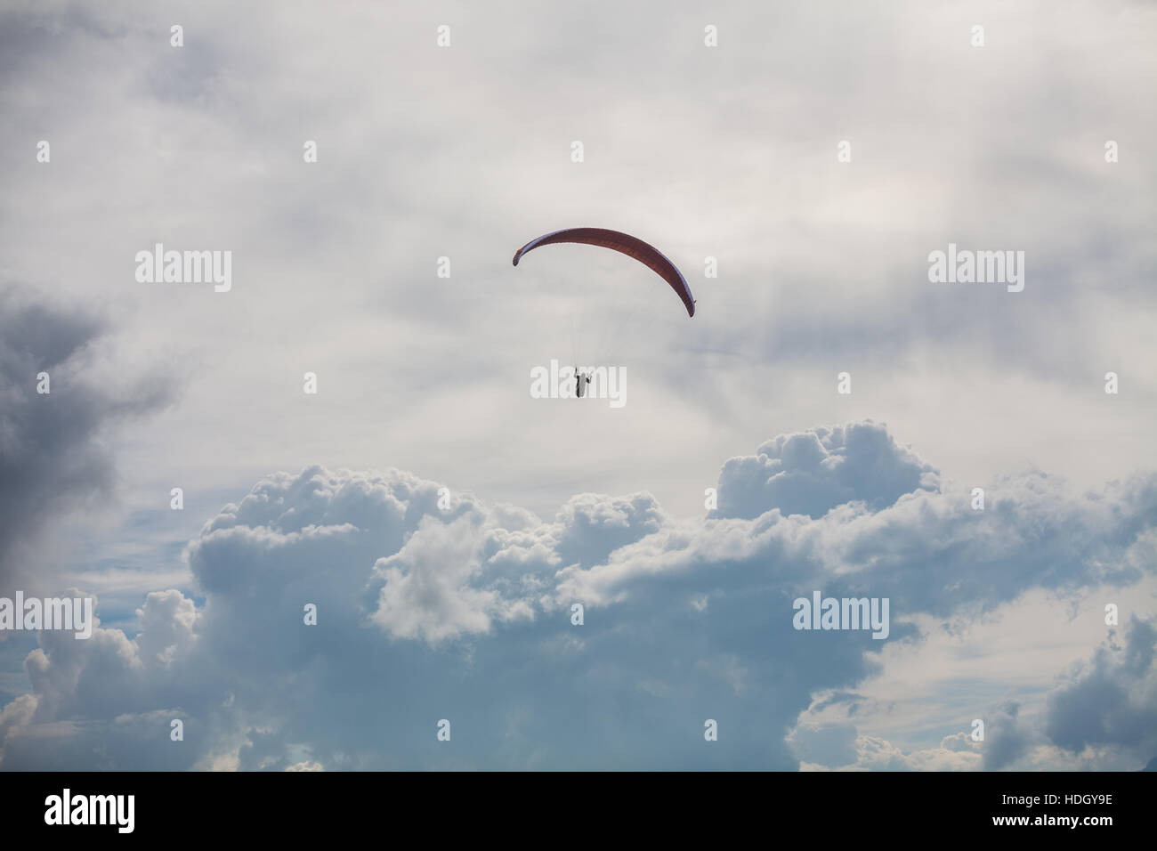 Color image of a paraglider flying, with clouds in the background Stock ...