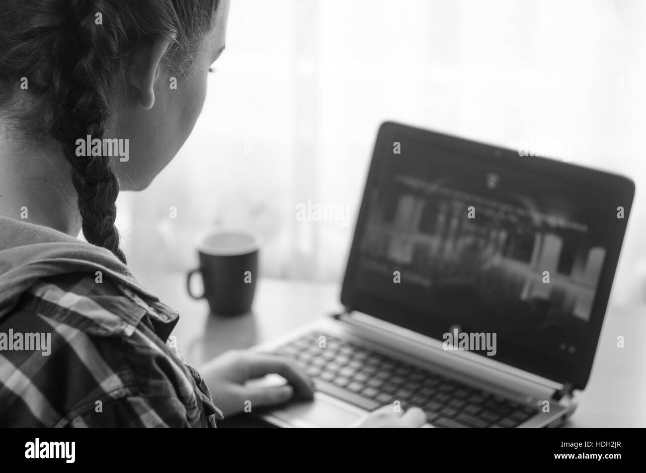 Black and white image young woman working with laptop Stock Photo - Alamy