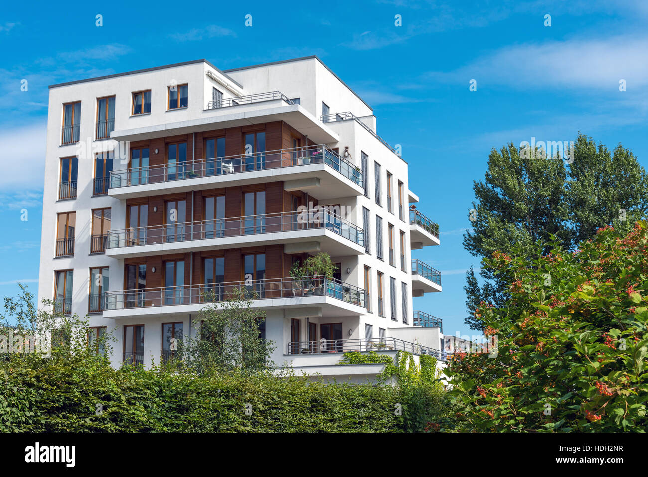 Modern block of flats with trees and bushes seen in Berlin, Germany ...
