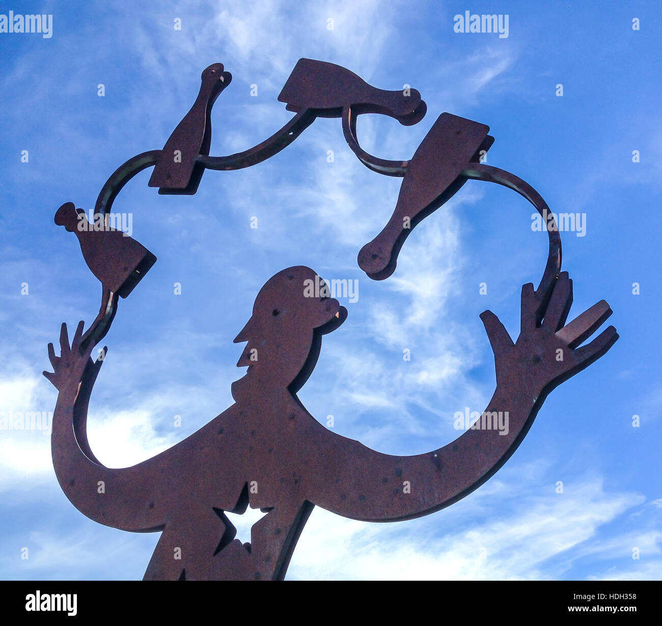 Rusted iron sculpture representing a juggler with bottles. Italy ...