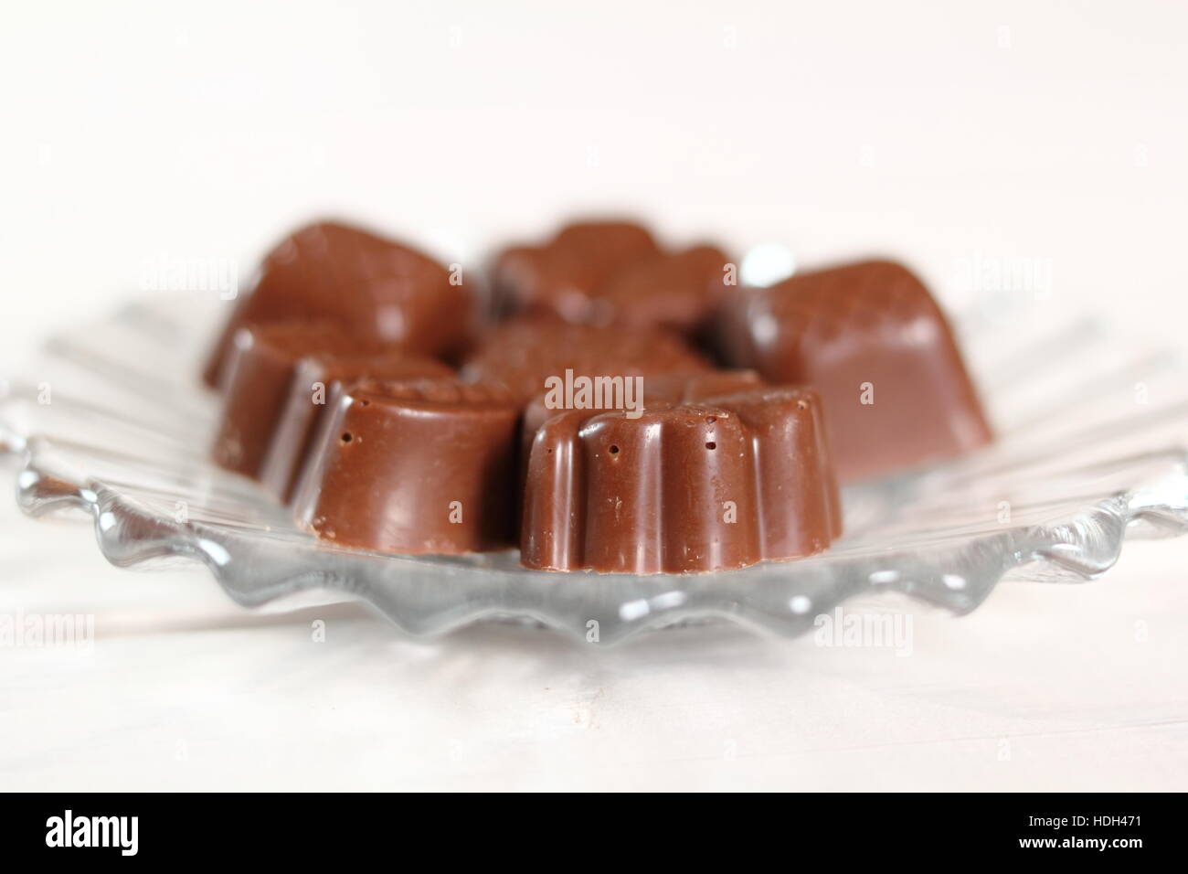 Chocolate Pralines on glass plate Stock Photo - Alamy