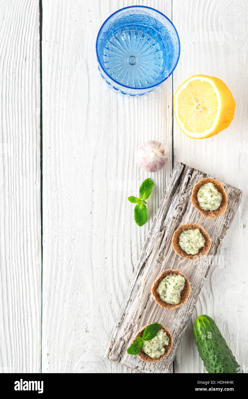 Crisp bread with tzatziki on the white wooden table vertical Stock ...
