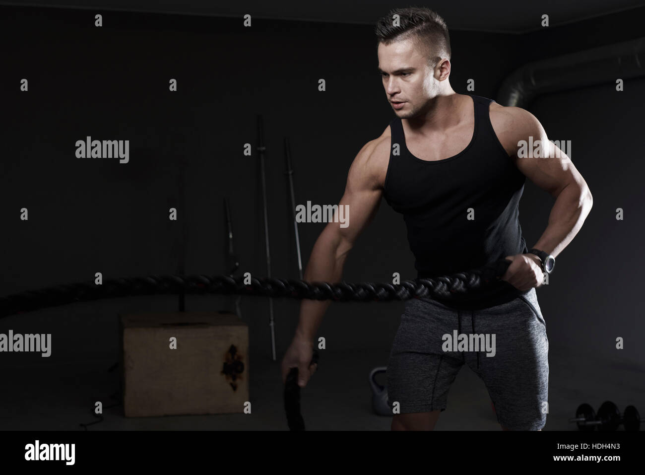 Strong man pulling exercise ropes Stock Photo - Alamy