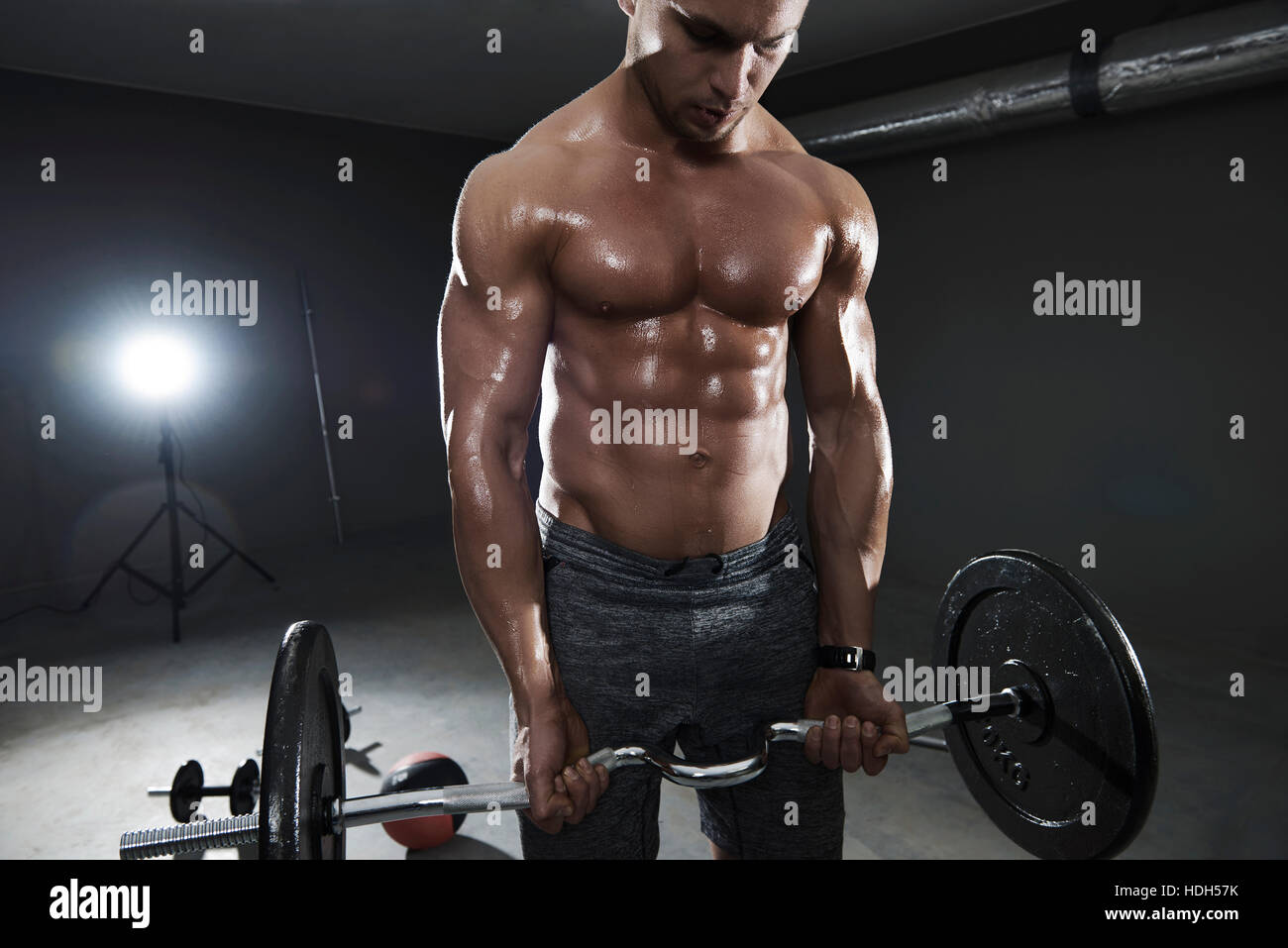 Shirtless man lifting heavy weights Stock Photo - Alamy
