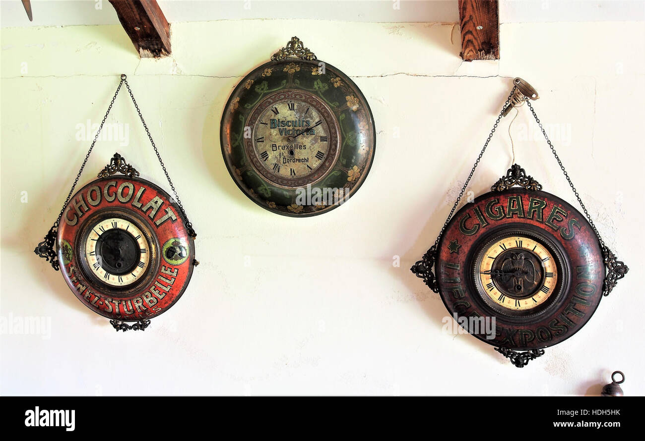 This image shows three antique tin clocks displayed in the Museum of ...