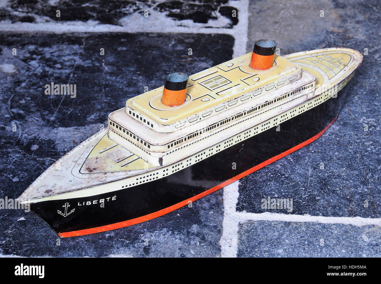 This image features a tin model of the Ship Liberte, displayed at the ...