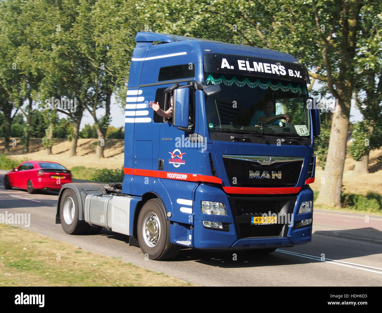 The image depicts large transport trucks, typically used for freight ...