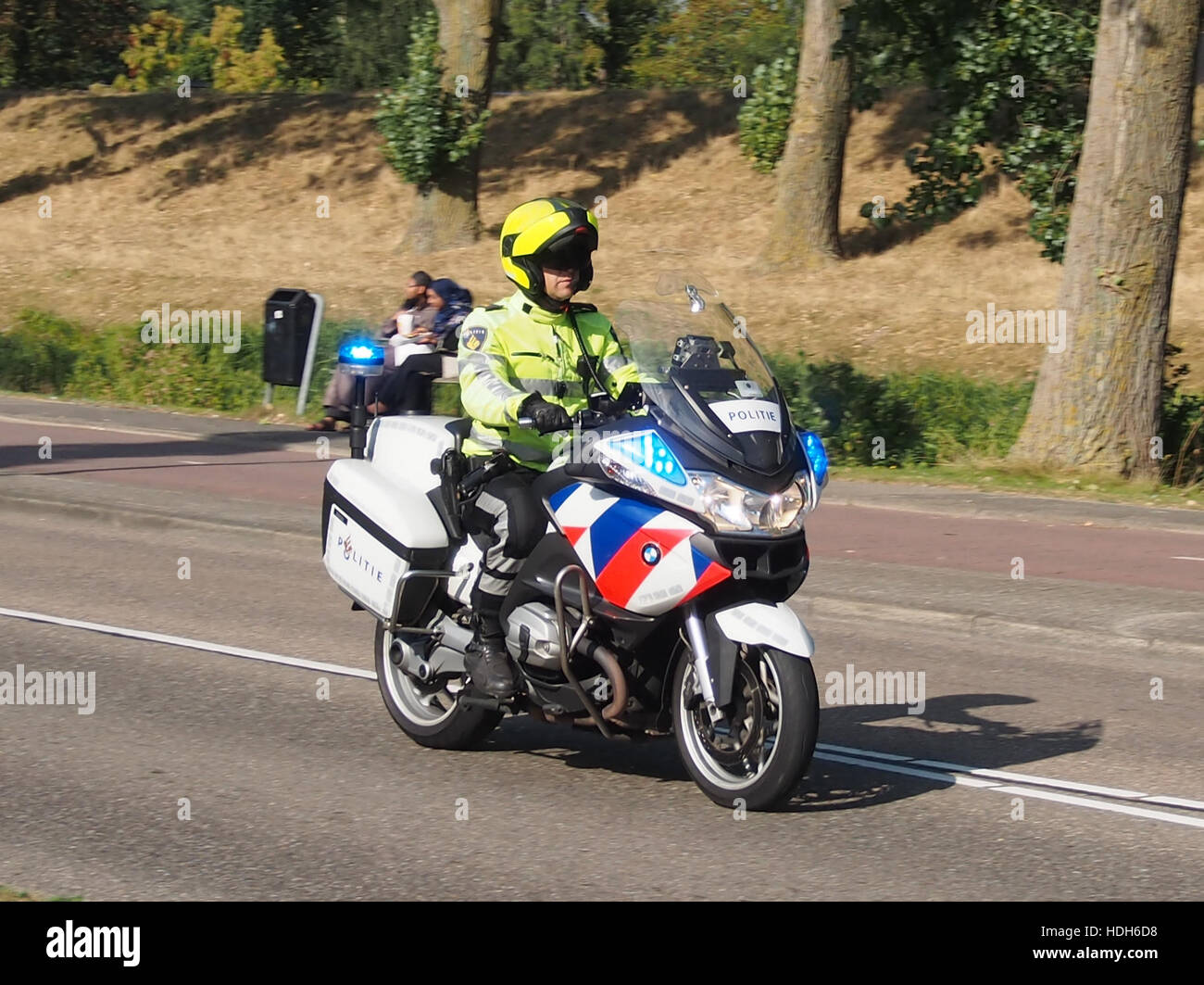 This image captures a BMW police motorcycle providing an escort for the ...