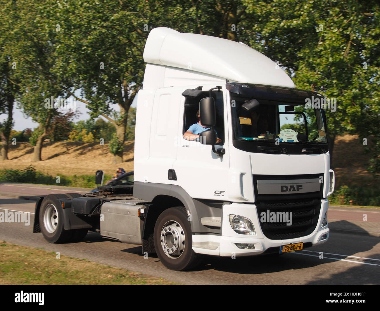 This image depicts a large truck engaged in vehicle transport ...