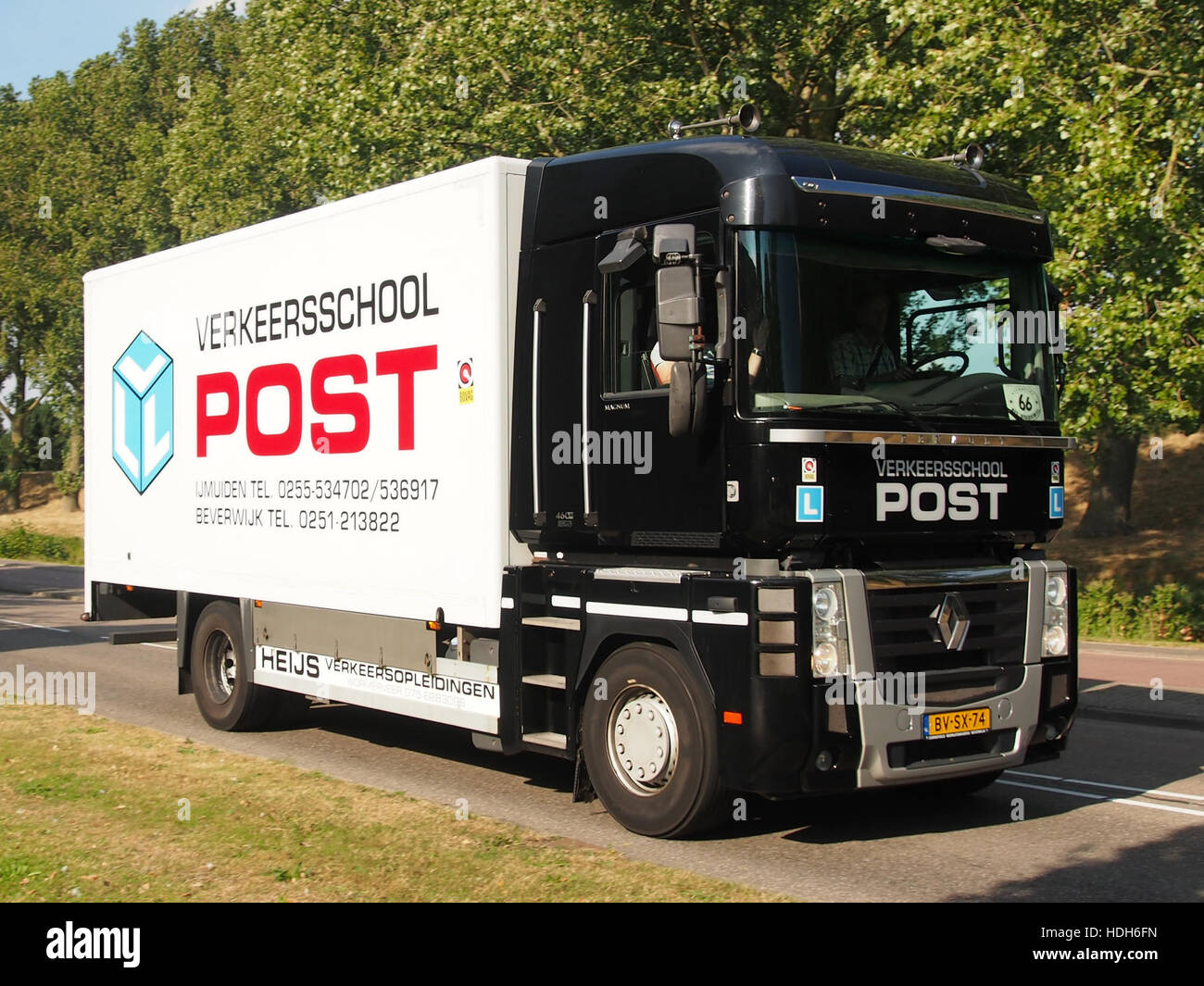 This image shows a large truck transporting vehicles, commonly used for ...