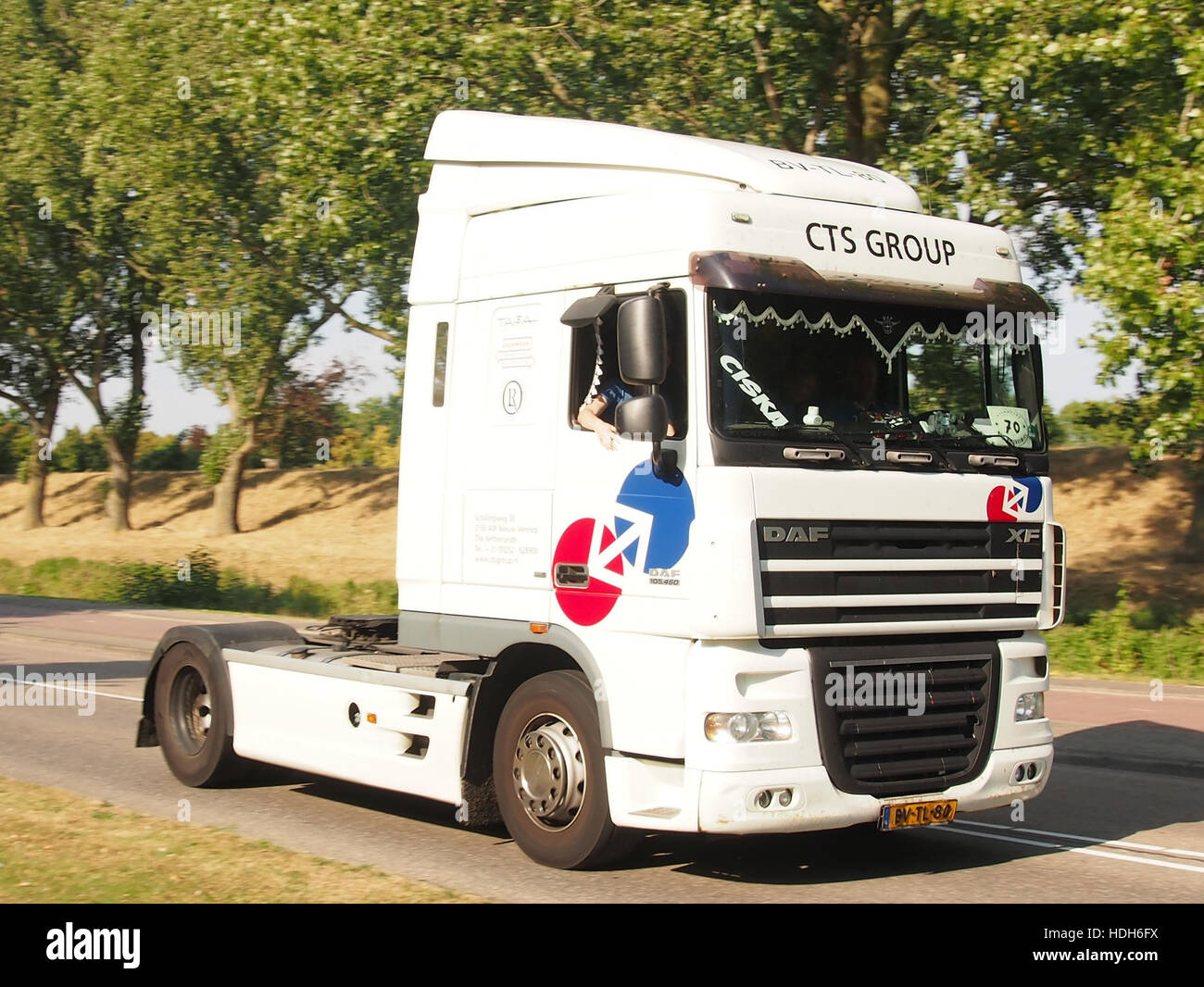 This image shows a large truck involved in transporting goods. The ...