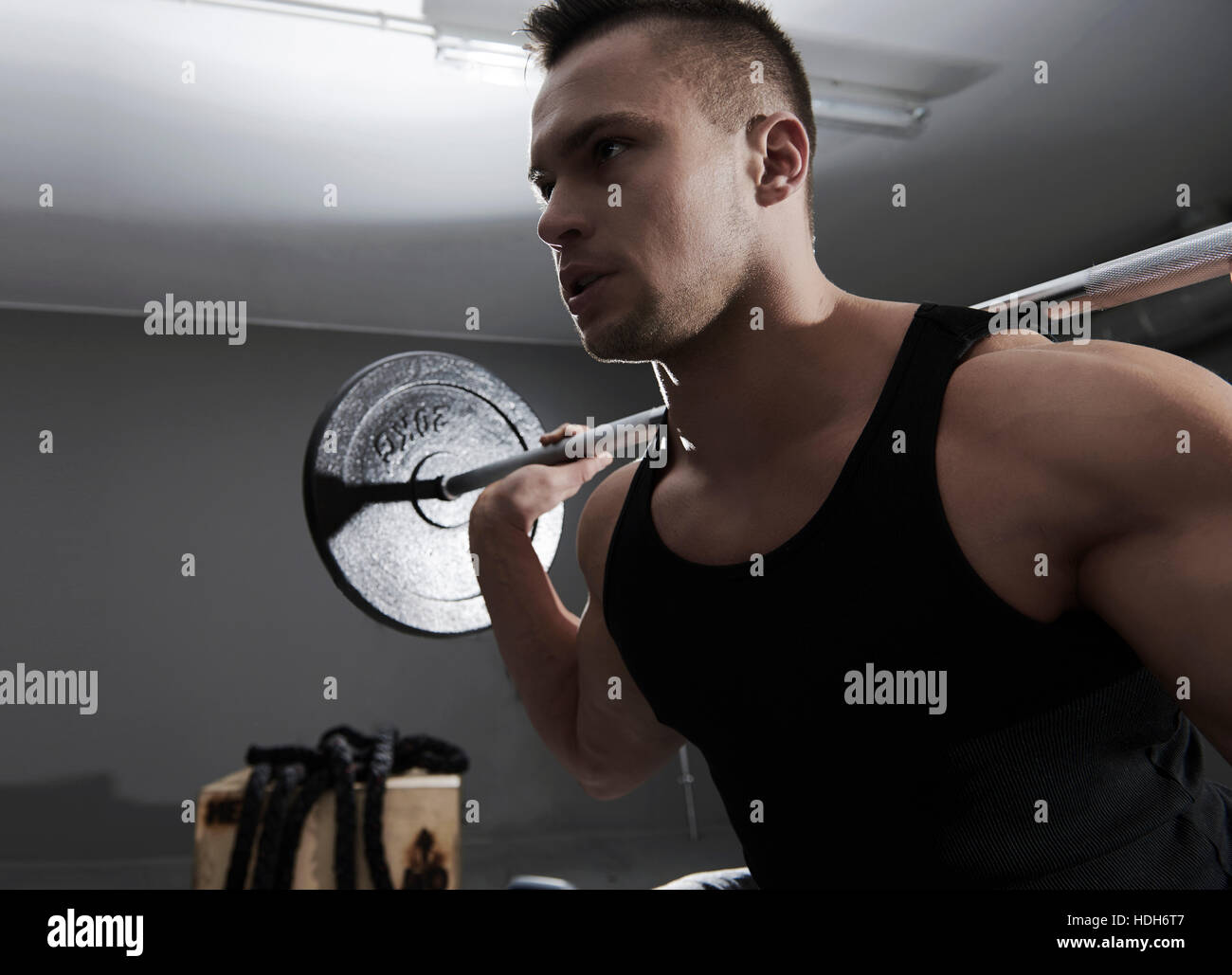 Heavy weight bar on human shoulders Stock Photo - Alamy