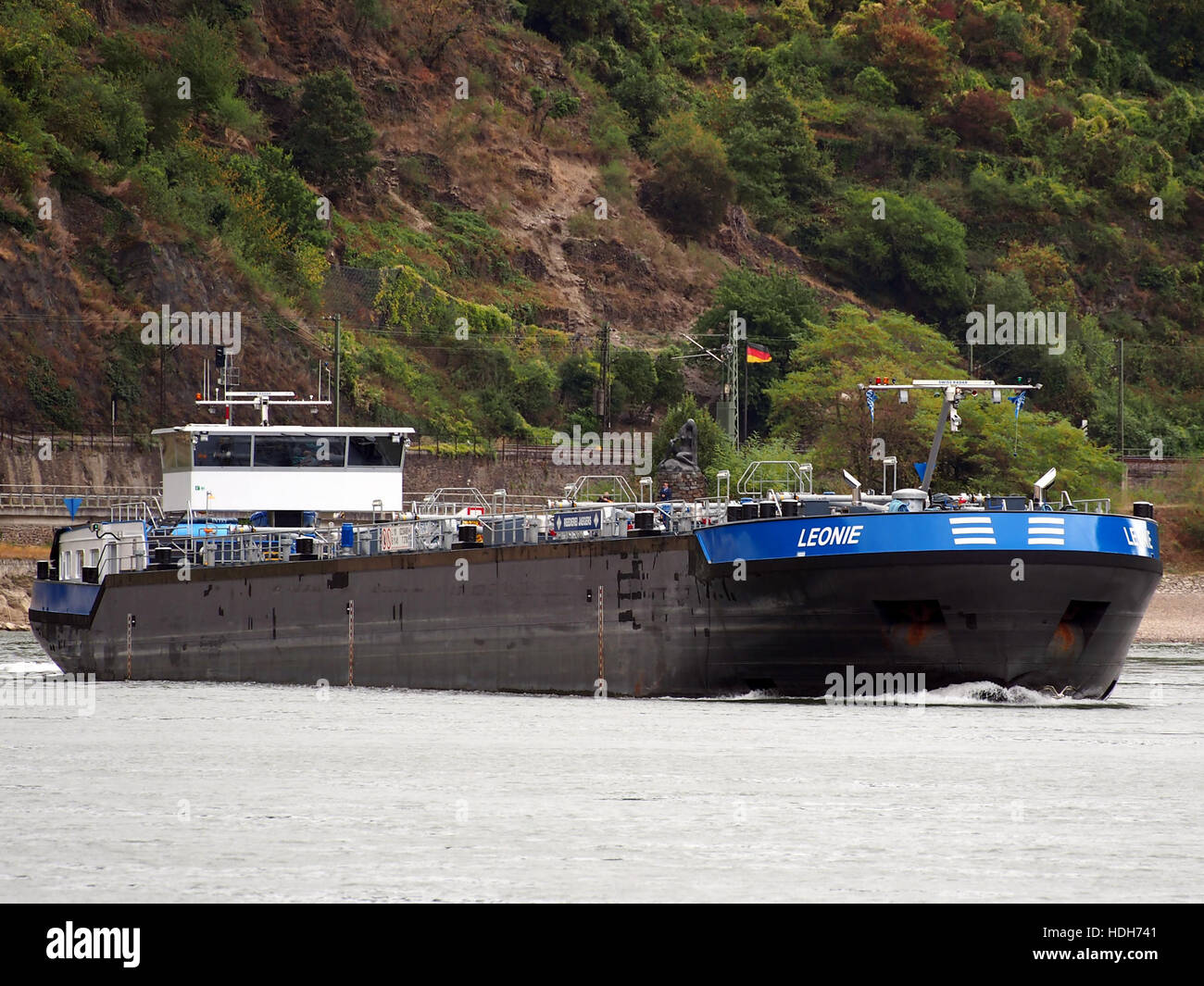 This photograph features a ship navigating the River Rhine. The Rhine ...