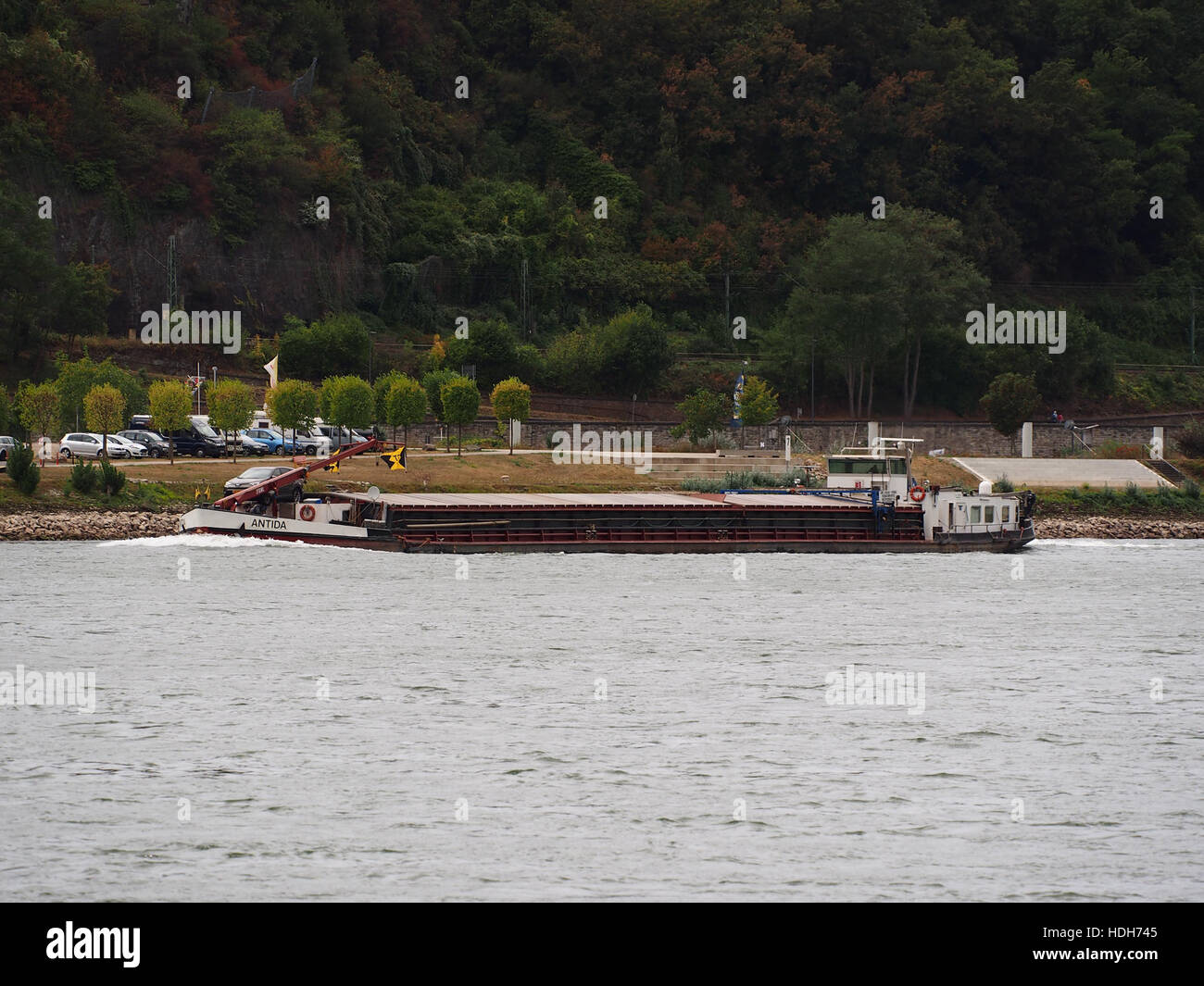 A vessel navigates the waters of the Rhine River, a major European ...